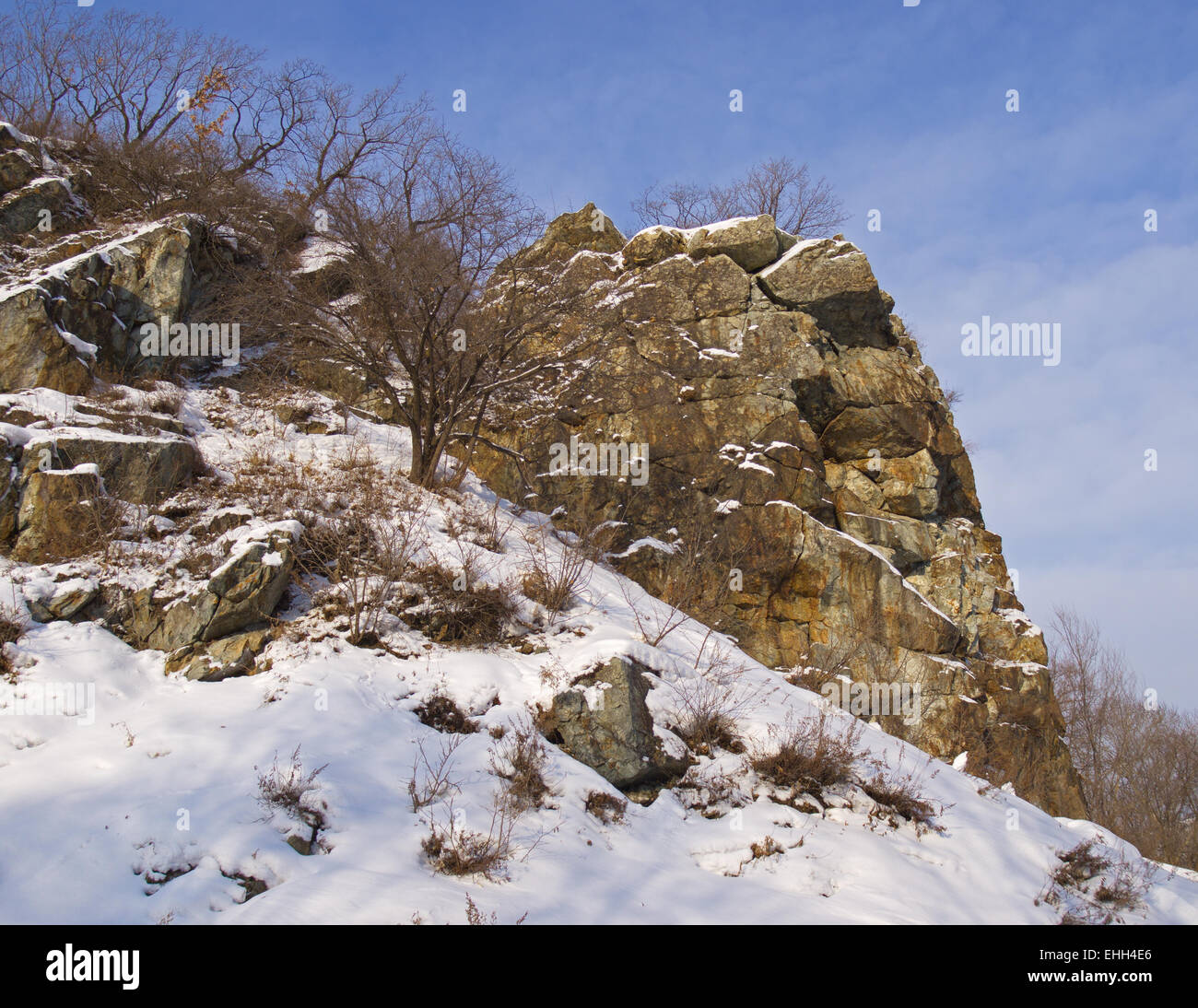 Rock covered with snow Stock Photo - Alamy
