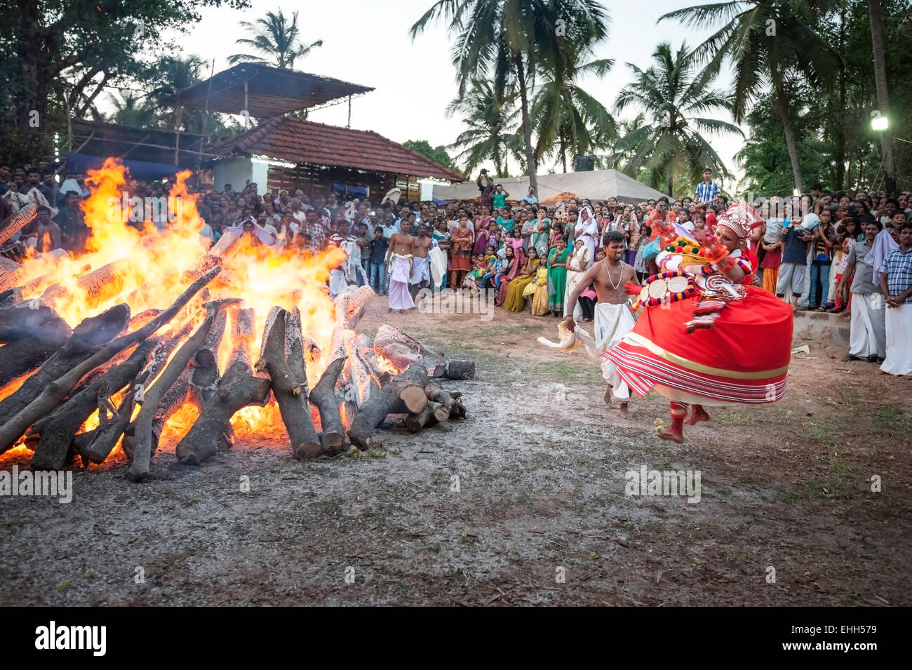 Theyyam Dancer (Tottan), moving around fire during performance Stock ...