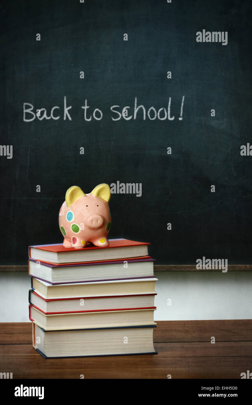 Piggy bank and books Stock Photo - Alamy