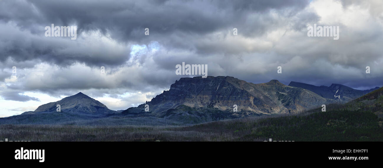 panaramic view of the dark clouds in the sky and mountains in Glacier ...