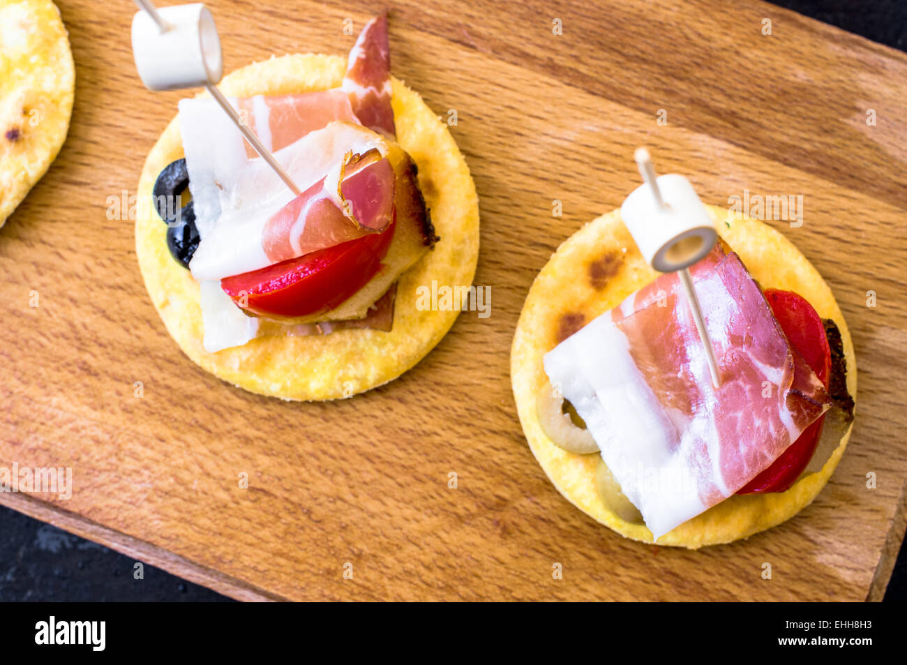 Tapas with bacon and potatoes, olives and tomatoes Stock Photo - Alamy