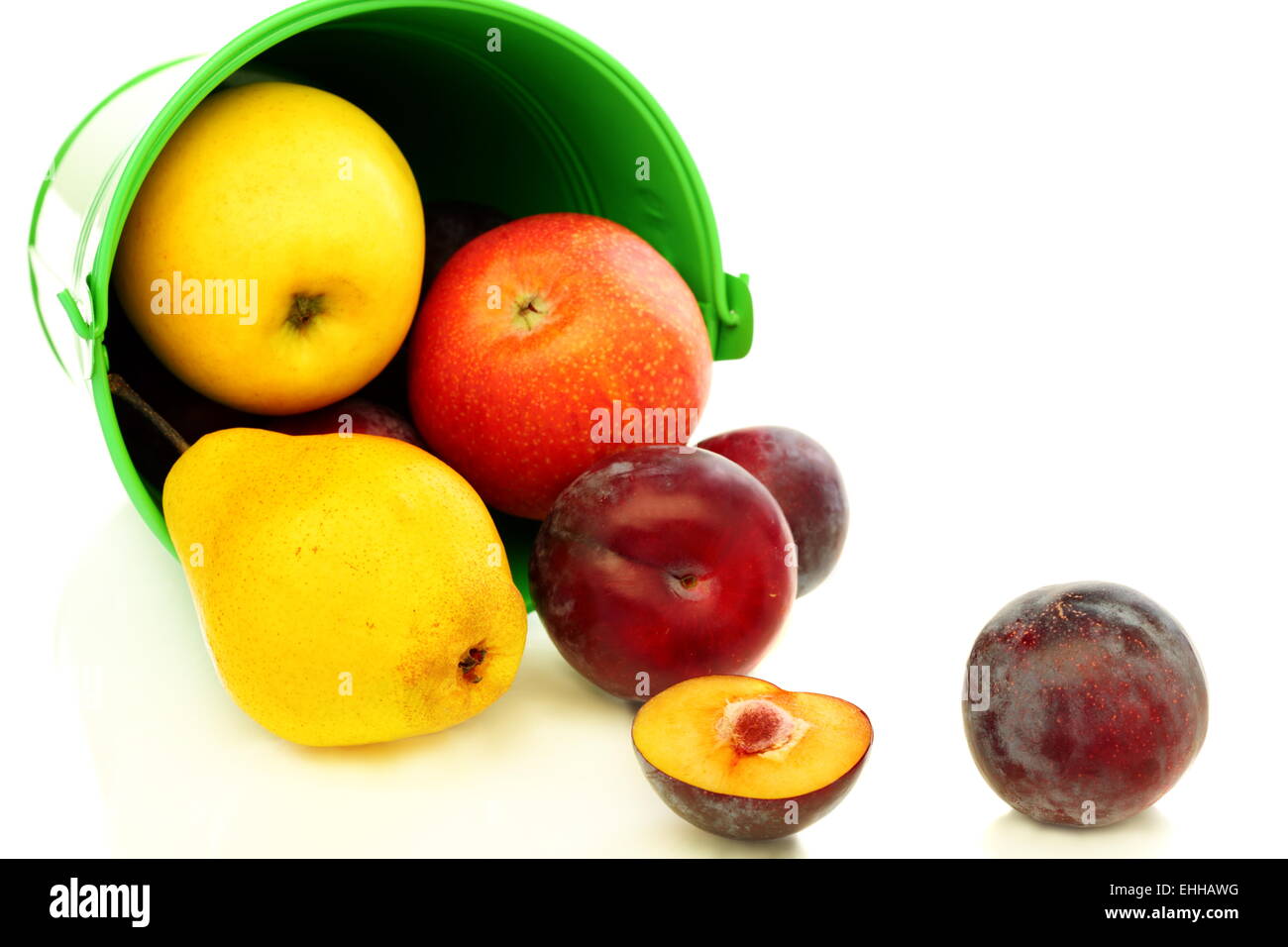 Summer fruits spilling from green bucket Stock Photo - Alamy