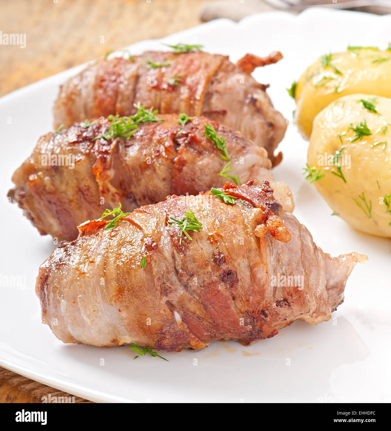 Grilled meat rolls wrapped in strips of bacon Stock Photo - Alamy
