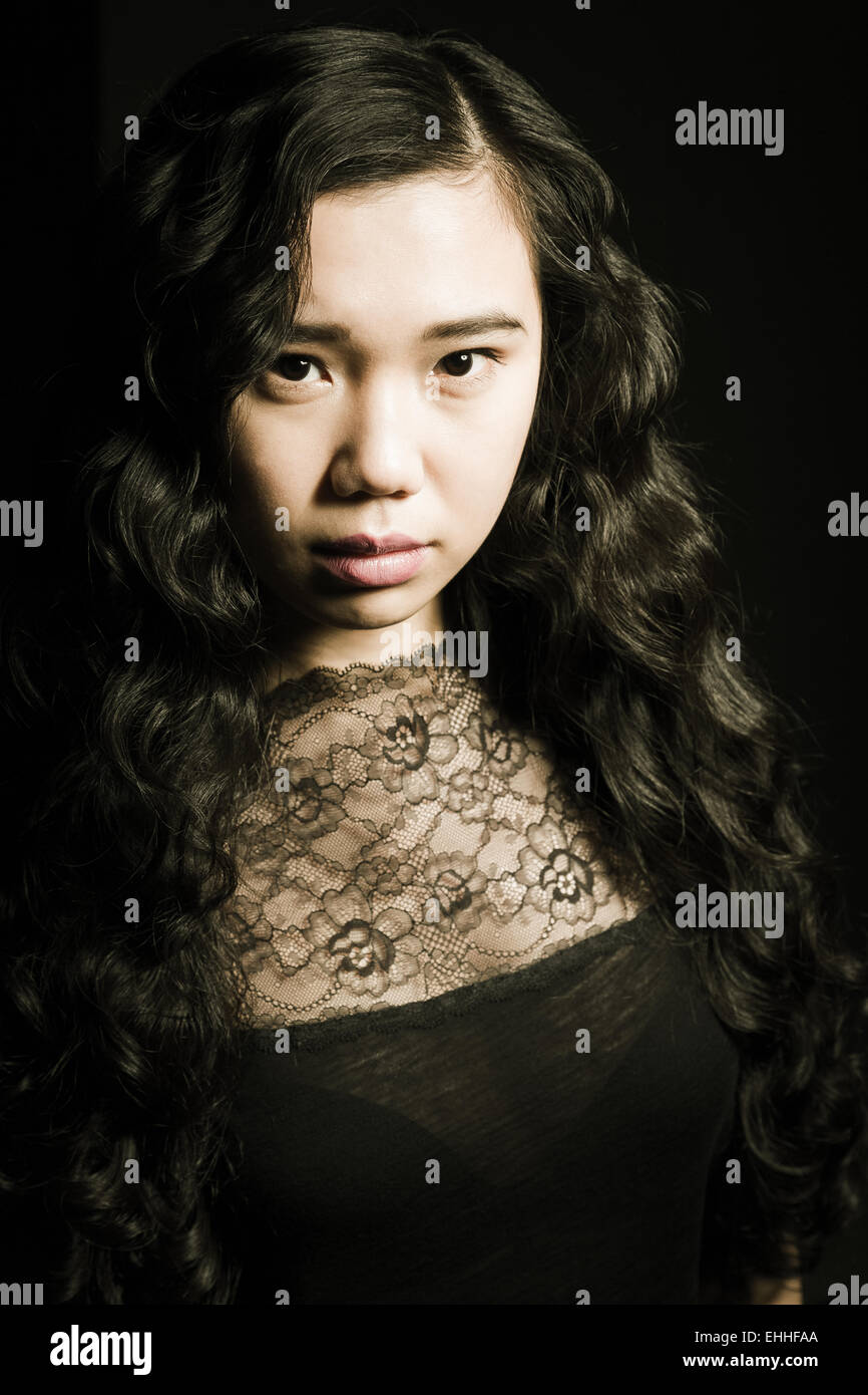 Portrait Of Beautiful Fashion Model With Long Hair Posing Over Black