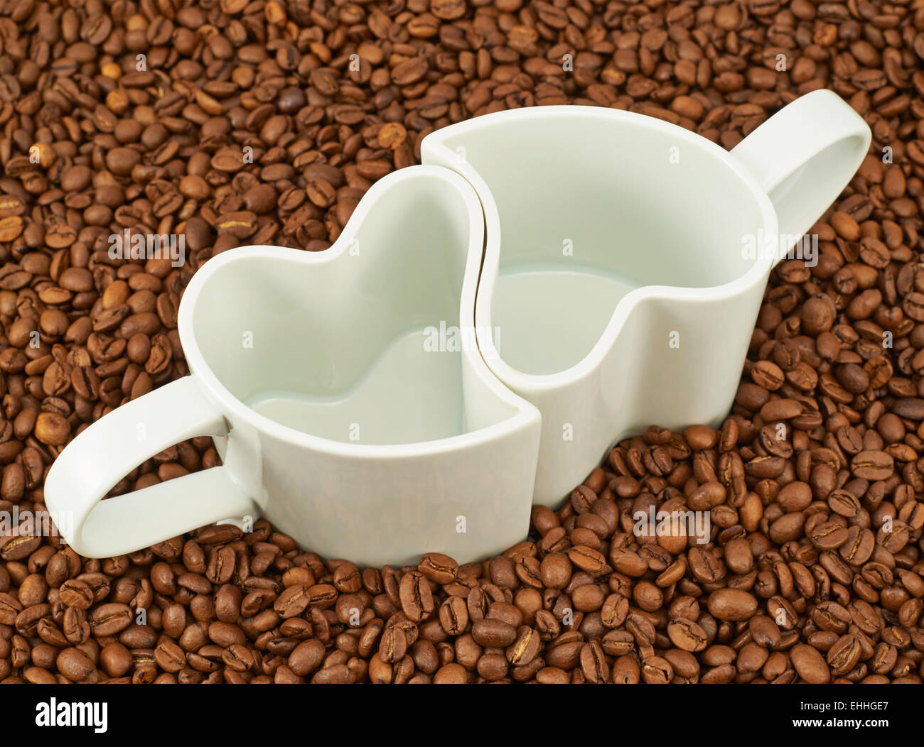 Two empty cups on coffee beans Stock Photo - Alamy