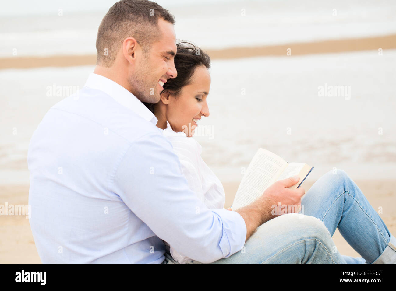 Couple reading book Stock Photo - Alamy