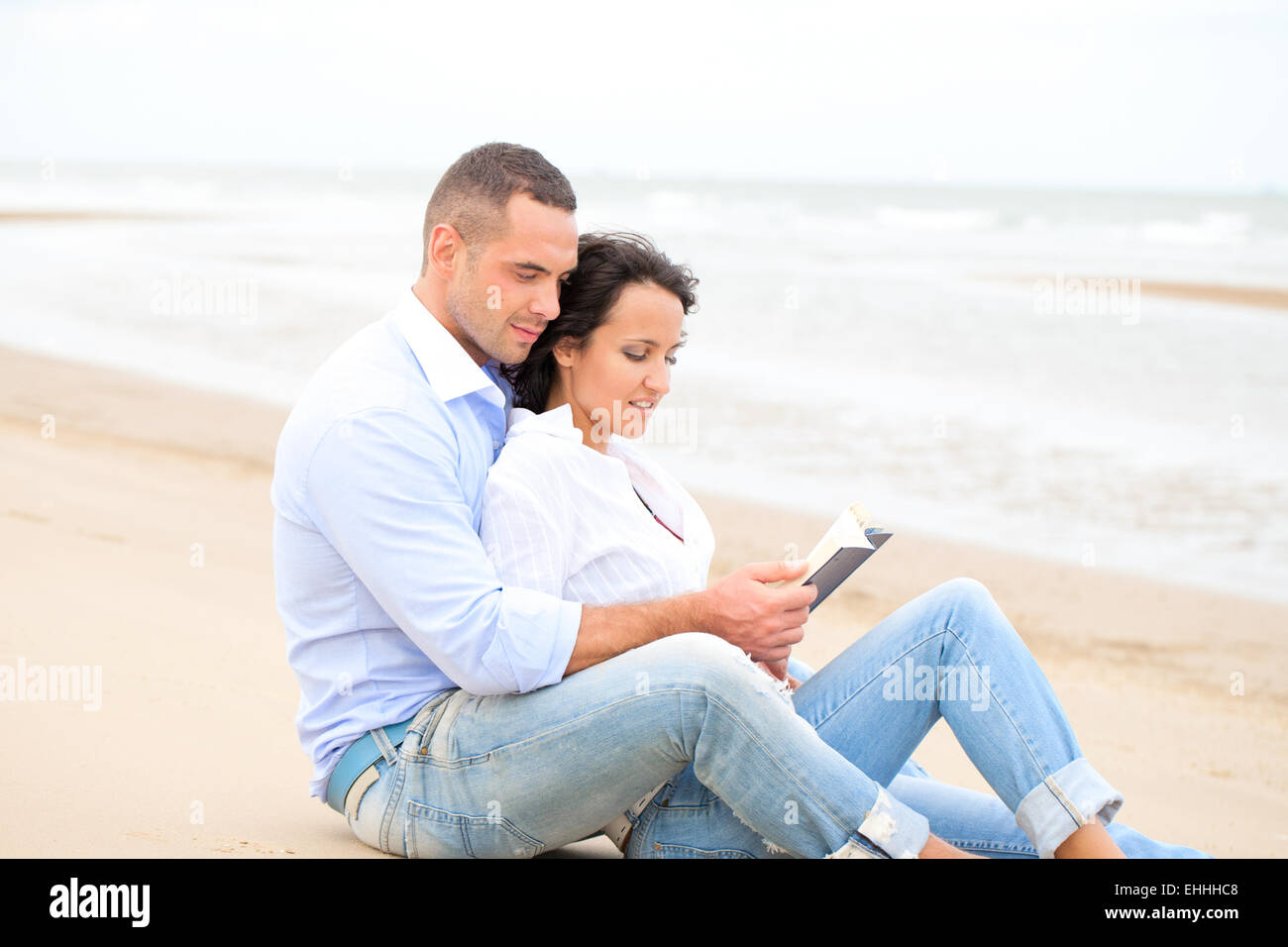 Couple reading book Stock Photo - Alamy