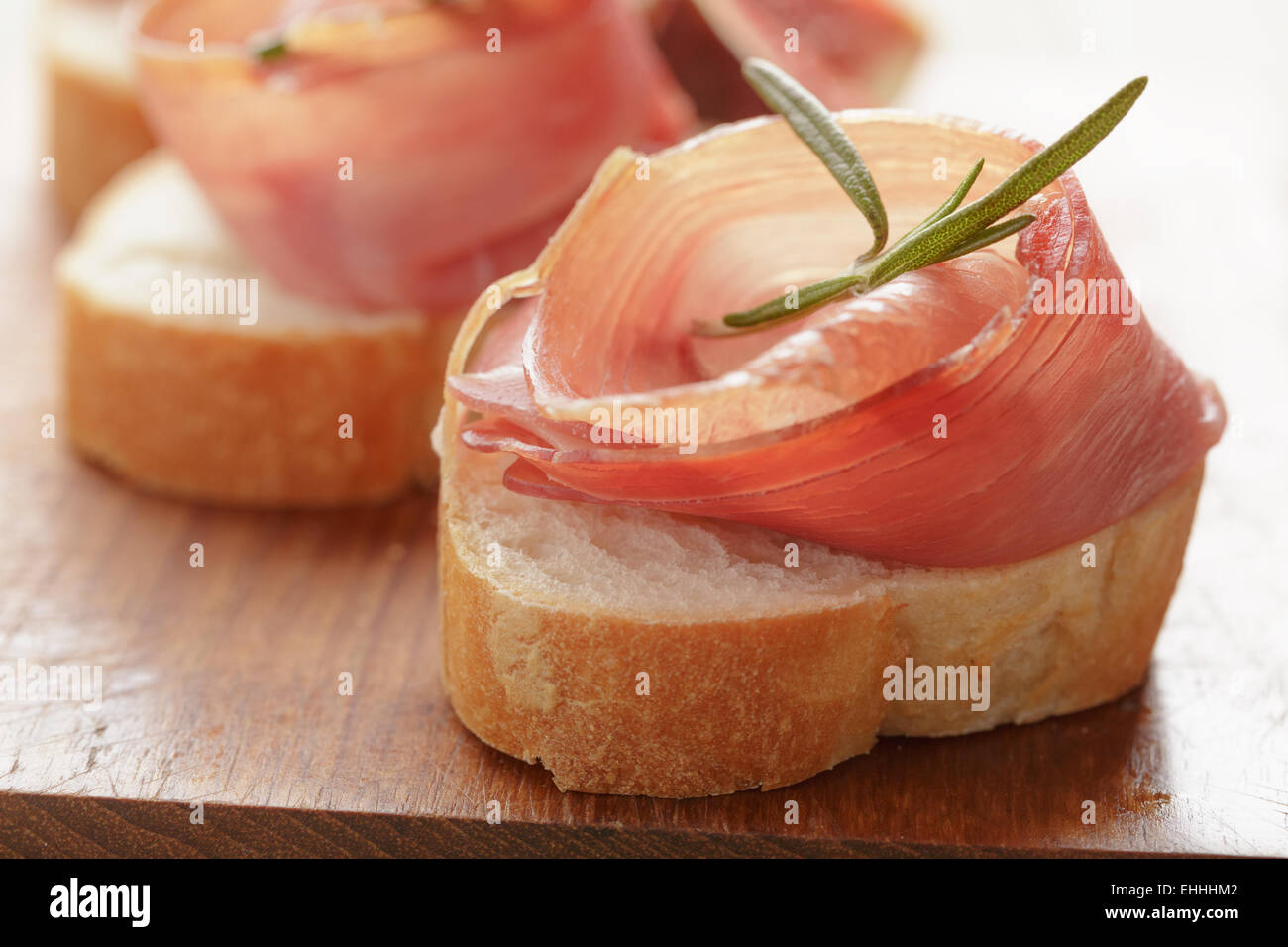 dried jamon slices on wood table, spanish food Stock Photo - Alamy