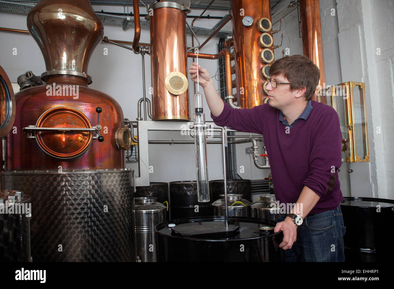 Worker testing the product at Sipsmith Independent Distillery in London ...