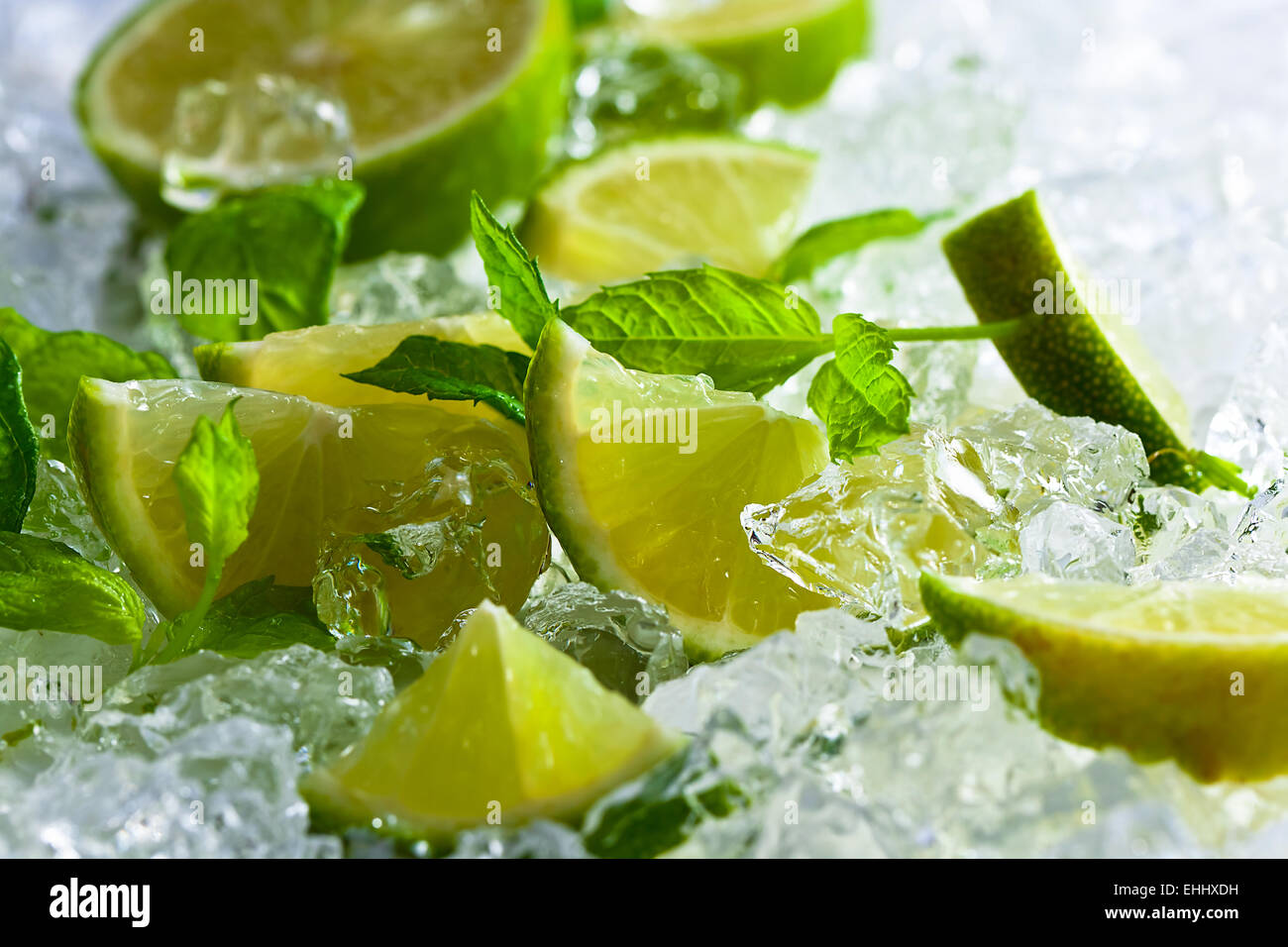 lime pieces and leaves of mint with ice Stock Photo - Alamy