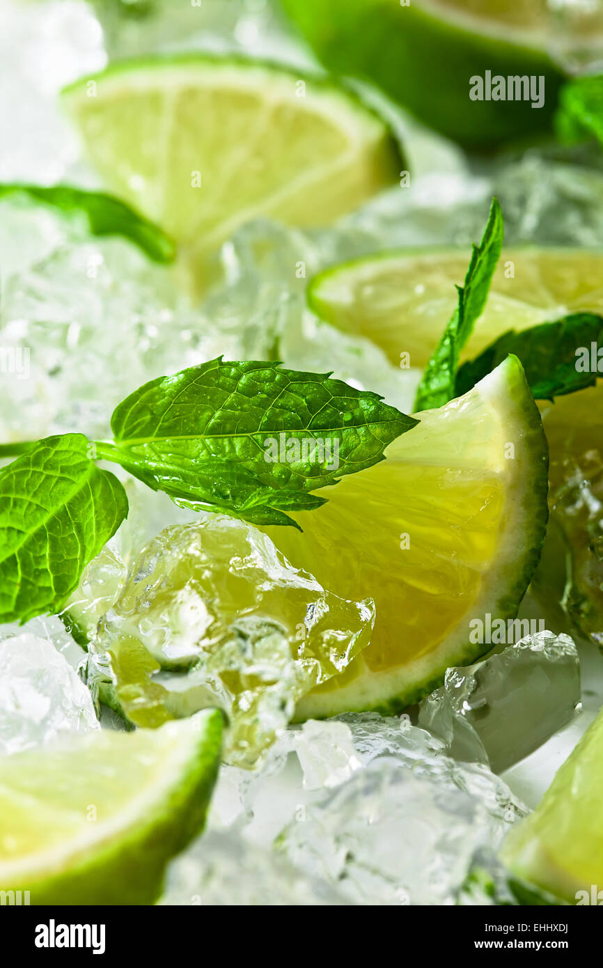 lime pieces and leaves of mint with ice Stock Photo - Alamy