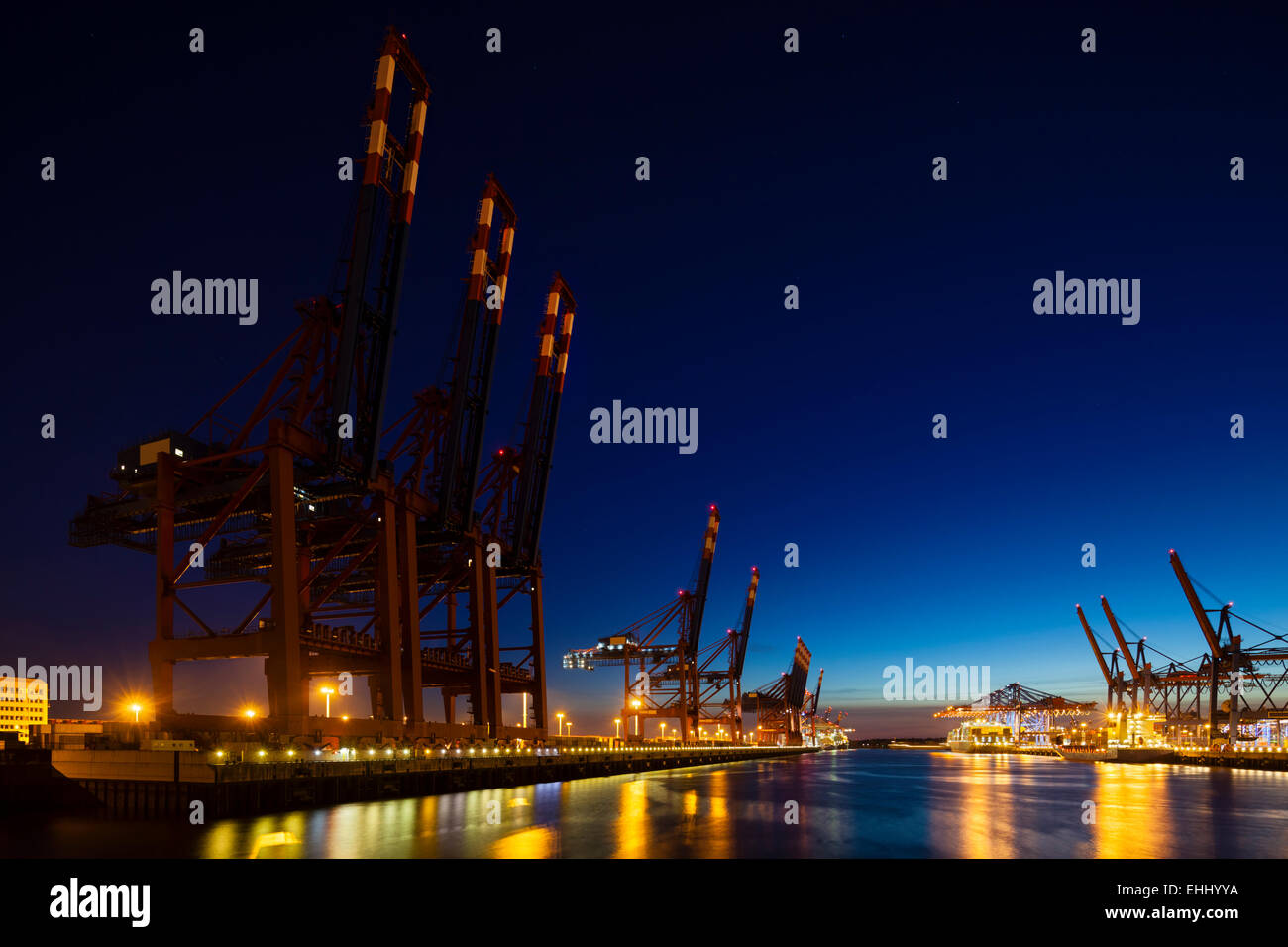 A large container harbor with deep blue night sky, taken with a shift ...