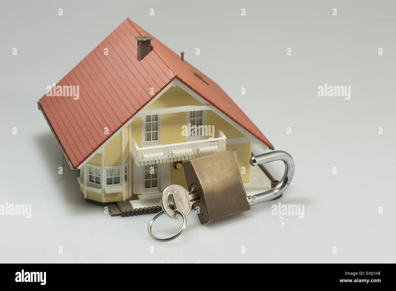 Model house with padlock Stock Photo - Alamy