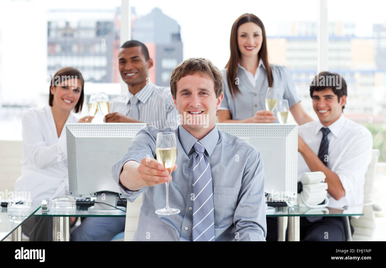 Fortunate business team drinking champagne Stock Photo - Alamy