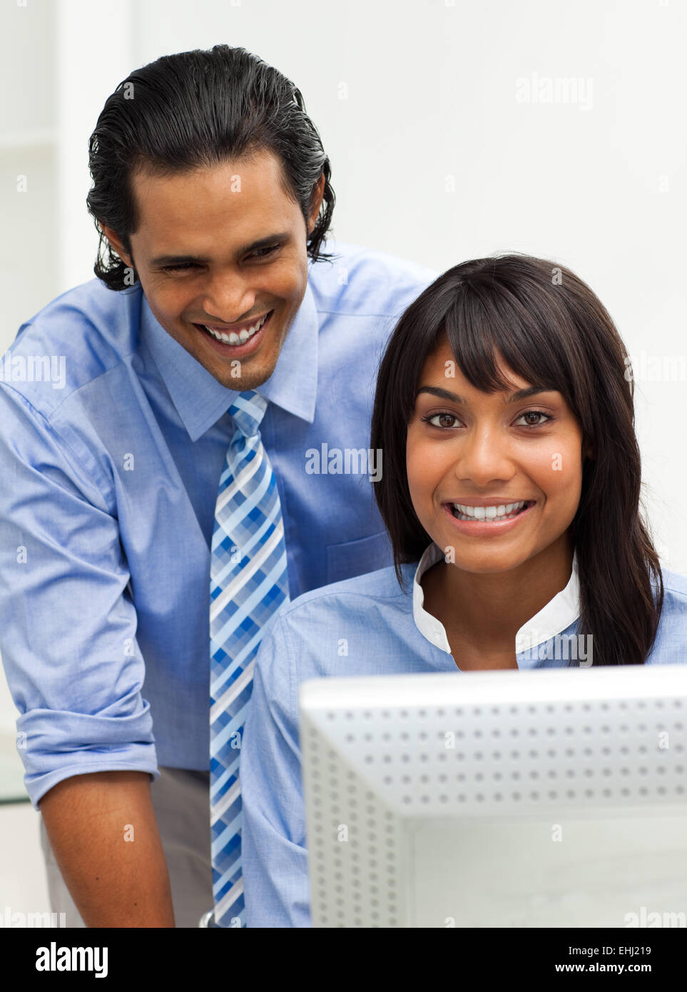 Smiling businessman helping his colleague Stock Photo - Alamy