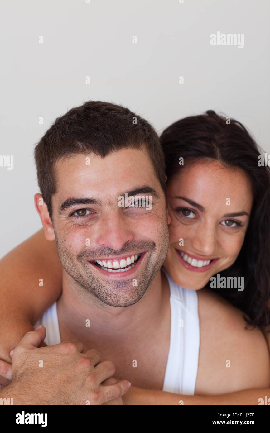 Enamoured couple smiling at camera Stock Photo - Alamy