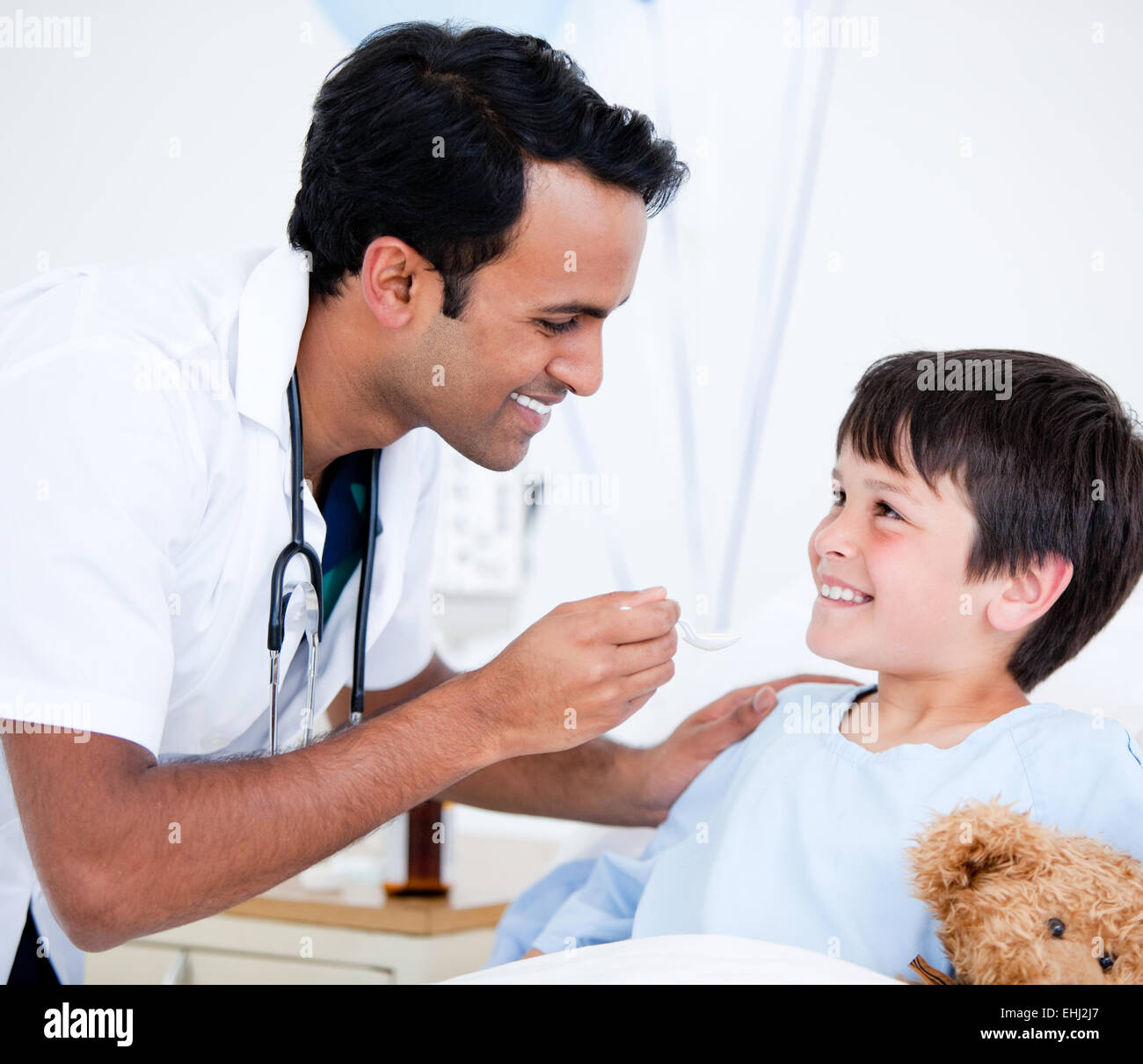 Smiling sick little boy taking medicine Stock Photo - Alamy