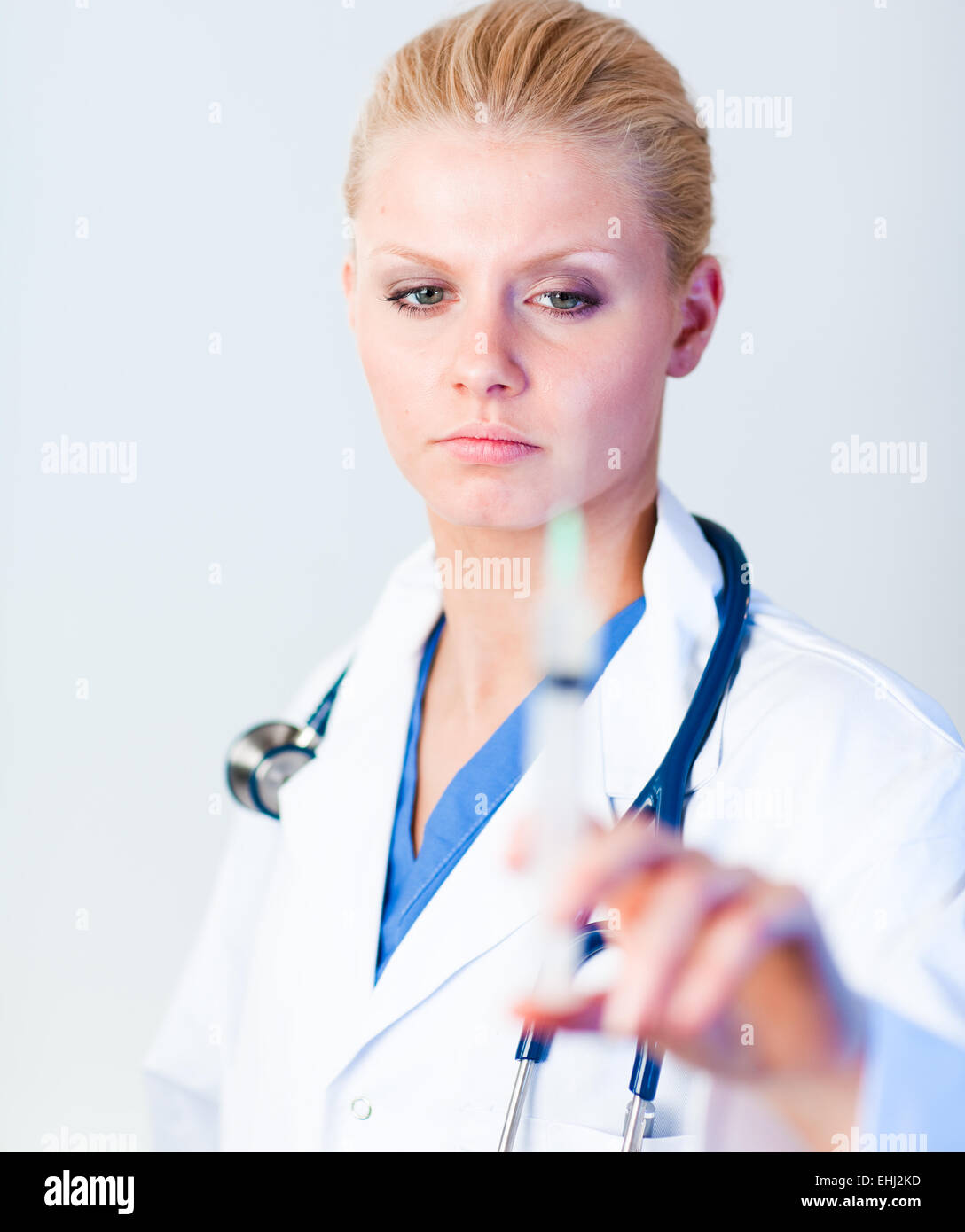 Serious Doctor holding a needle Stock Photo - Alamy