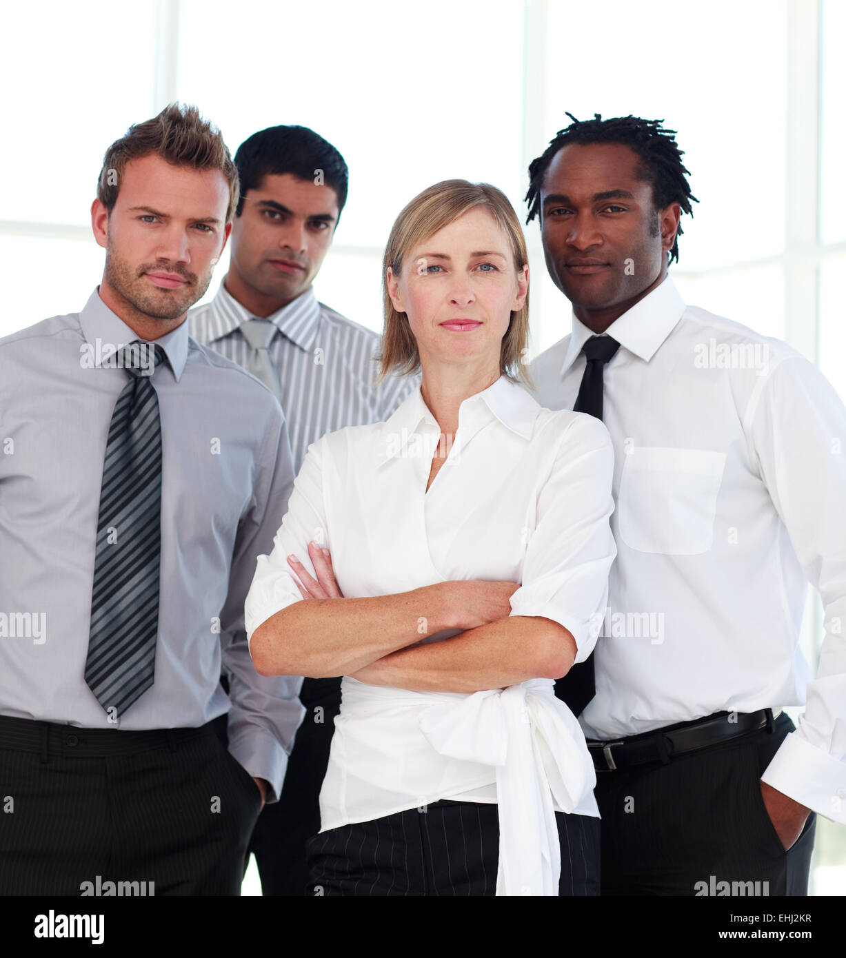 Serious team looking camera crossed hi-res stock photography and images ...