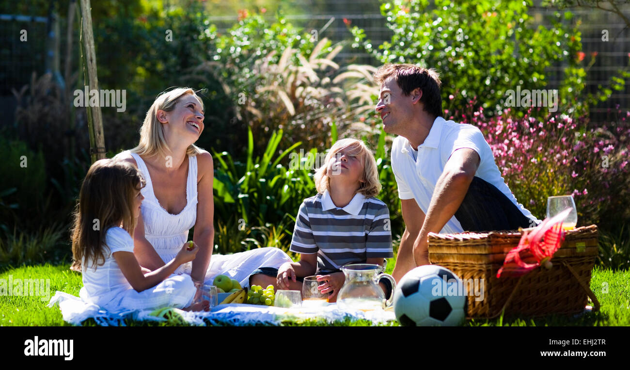 Happy family enjoying the sun in a picnic Stock Photo - Alamy