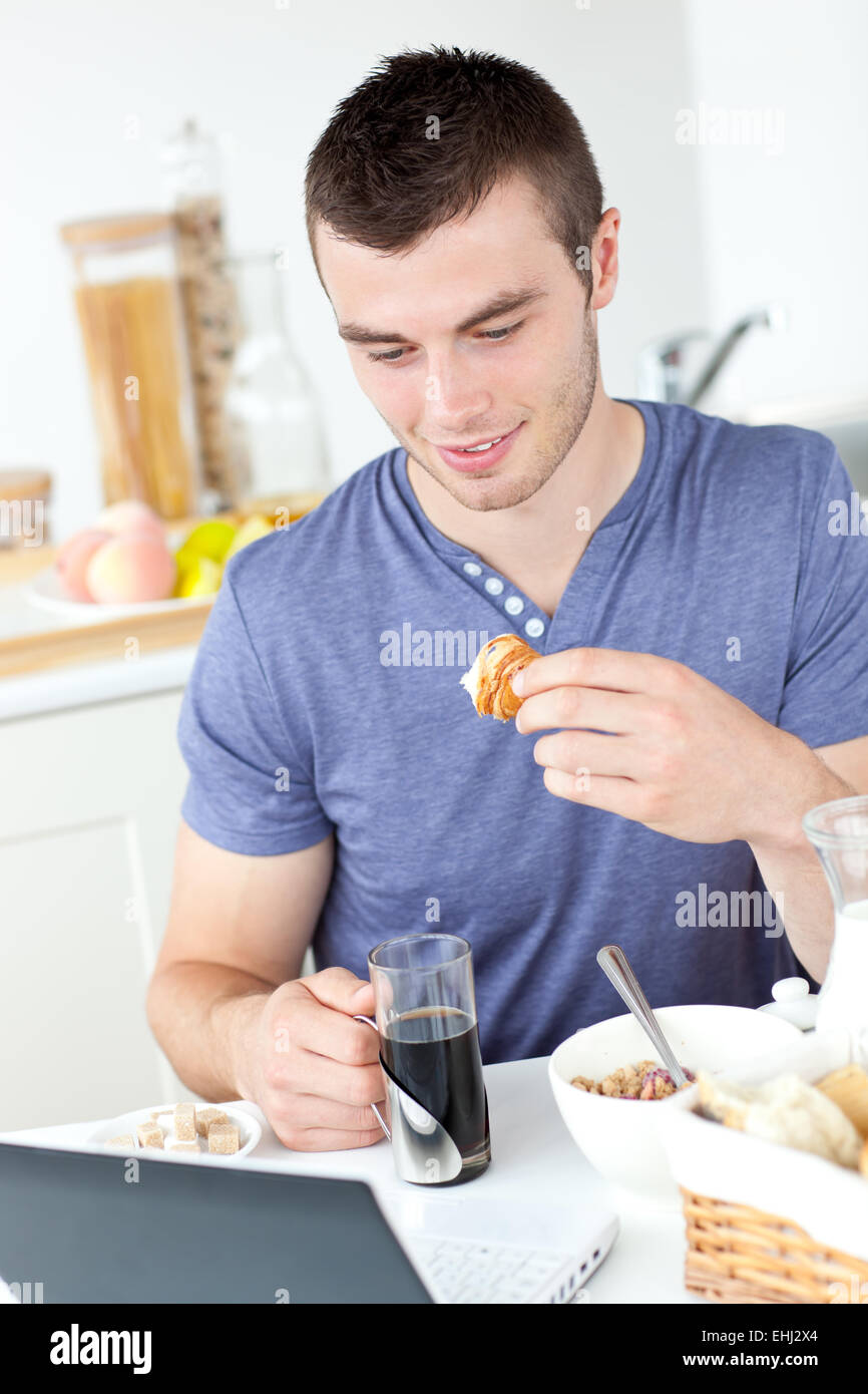 Smiling man having breakfast Stock Photo - Alamy