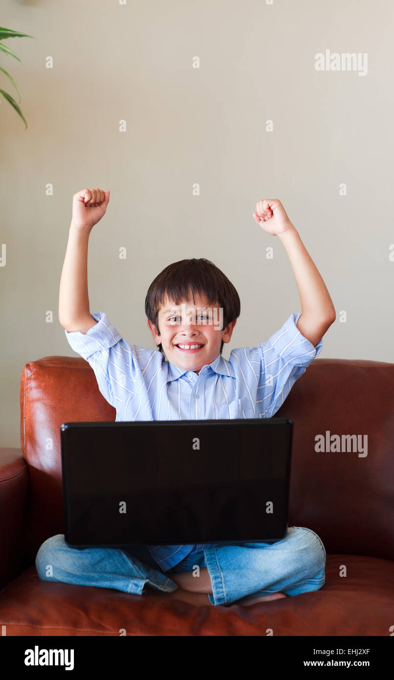 Happy child playing with his laptop Stock Photo - Alamy