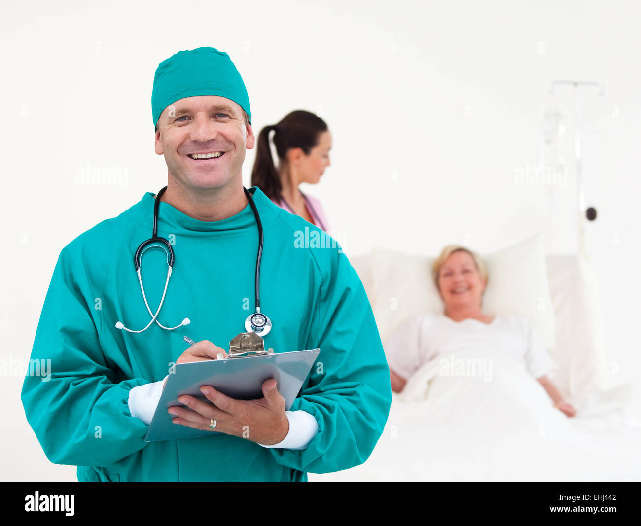 Handsome surgeon smiling at the camera Stock Photo - Alamy