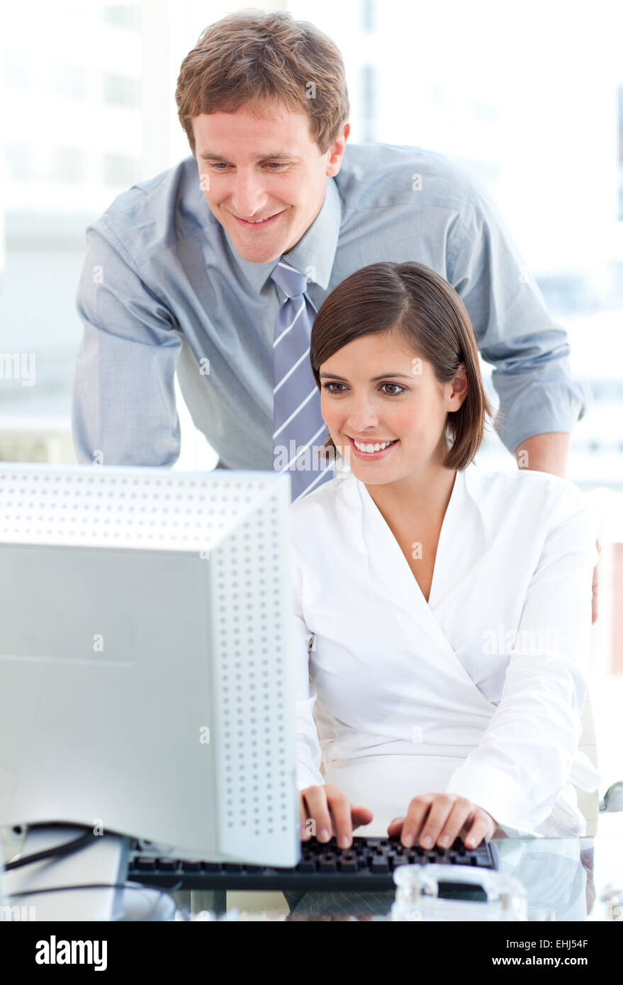 Young manager helping his colleague Stock Photo - Alamy