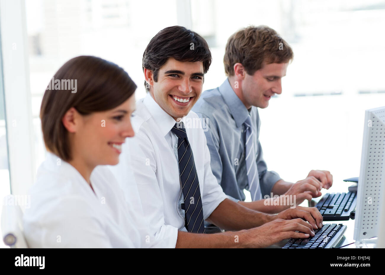 Positive business people working at computers Stock Photo - Alamy