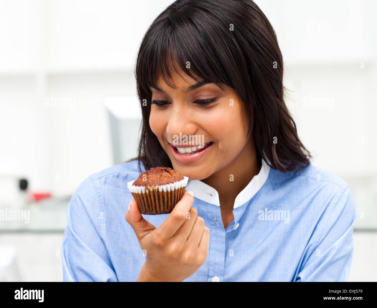 Close-up of a businesswoman eating a muffin Stock Photo - Alamy