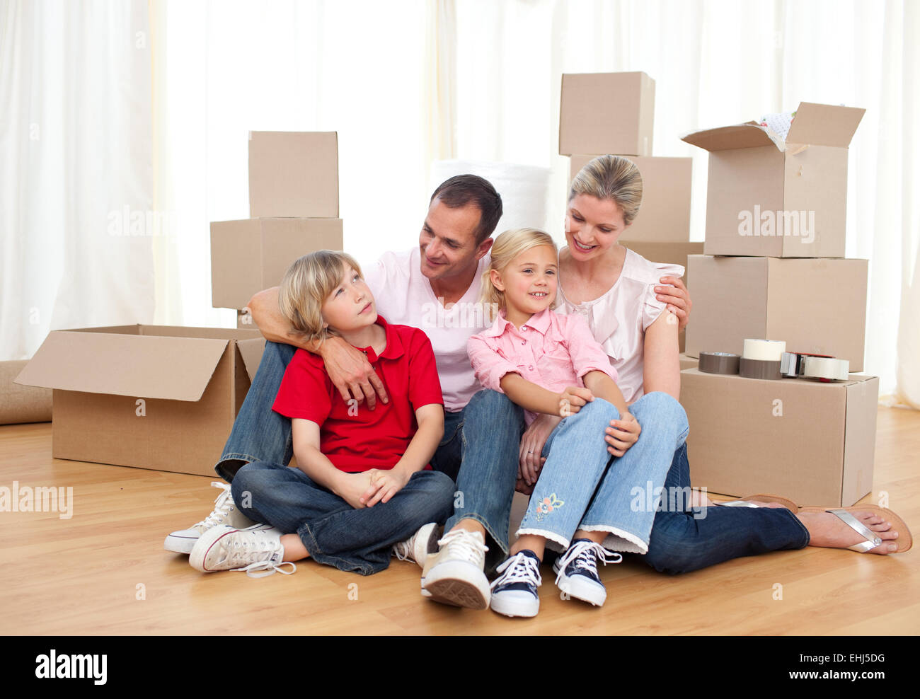 Tired family relaxing while moving house Stock Photo - Alamy