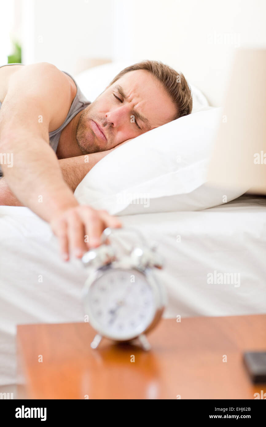Man waking up in his bed Stock Photo - Alamy
