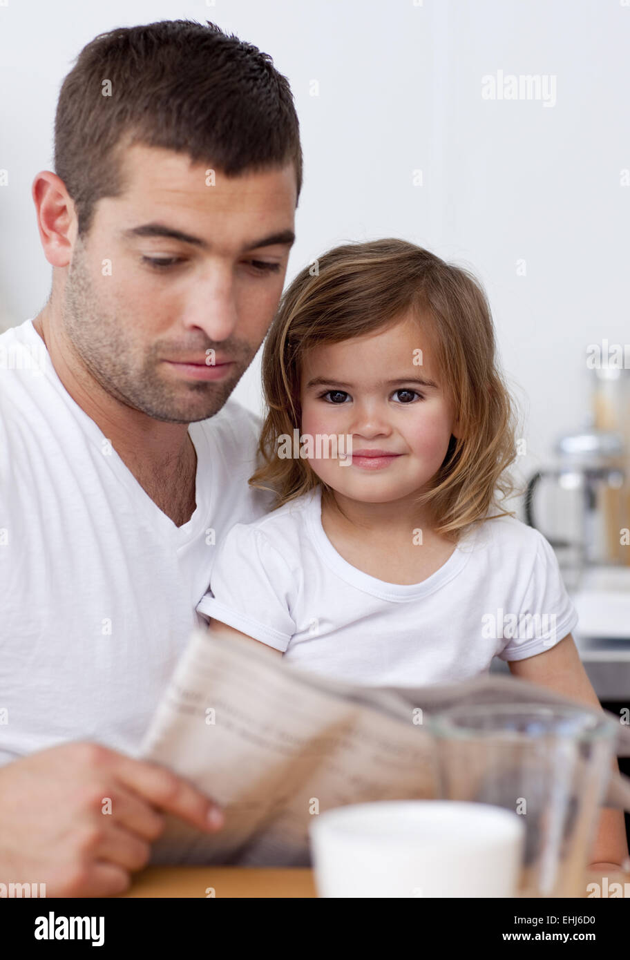 Father reading a newspaper with his daughter Stock Photo - Alamy