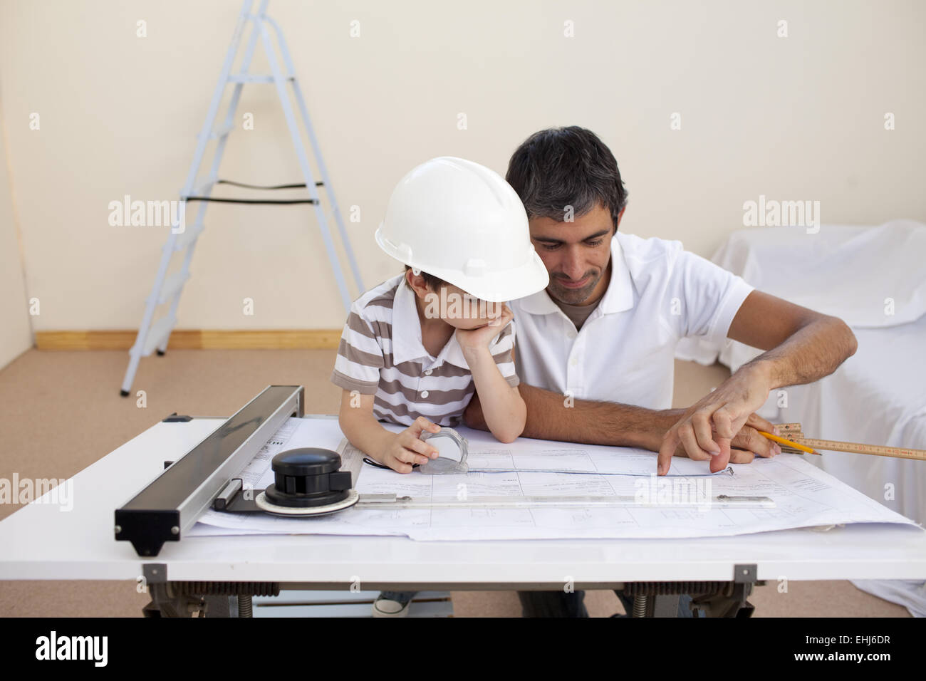 Father and son studying working with plans Stock Photo - Alamy