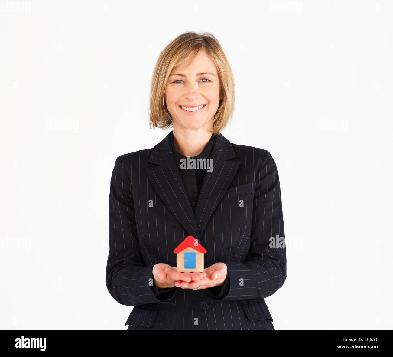 Female business manager holding house Stock Photo - Alamy