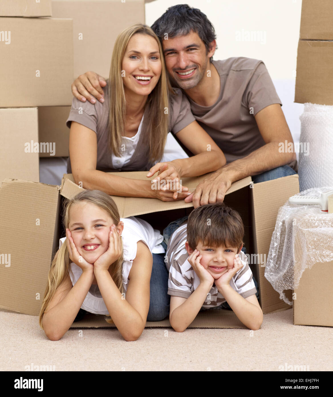 Family in new house playing with boxes Stock Photo - Alamy