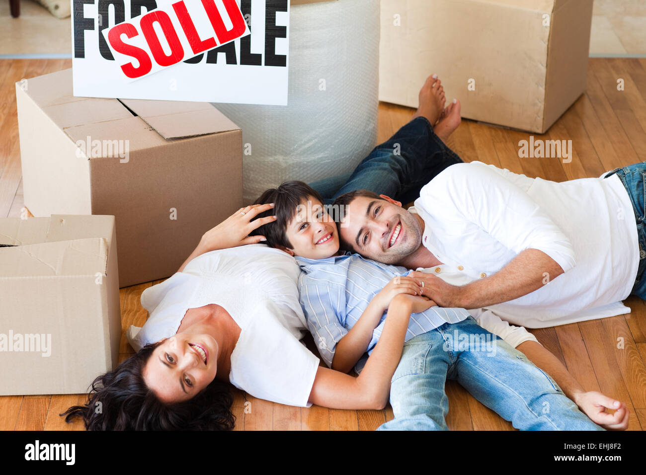 Parents and son moving house lying on floor Stock Photo - Alamy