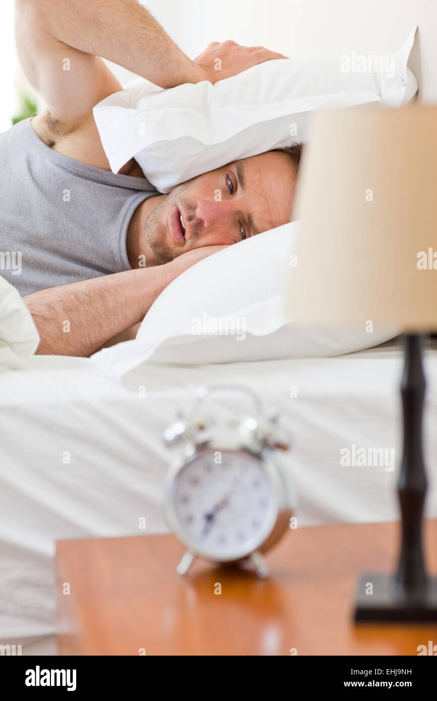 Man waking up in his bed Stock Photo - Alamy