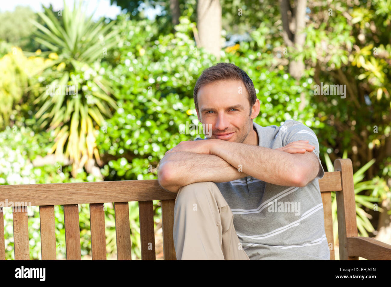 Portrait of a man sitting on a bench Stock Photo - Alamy