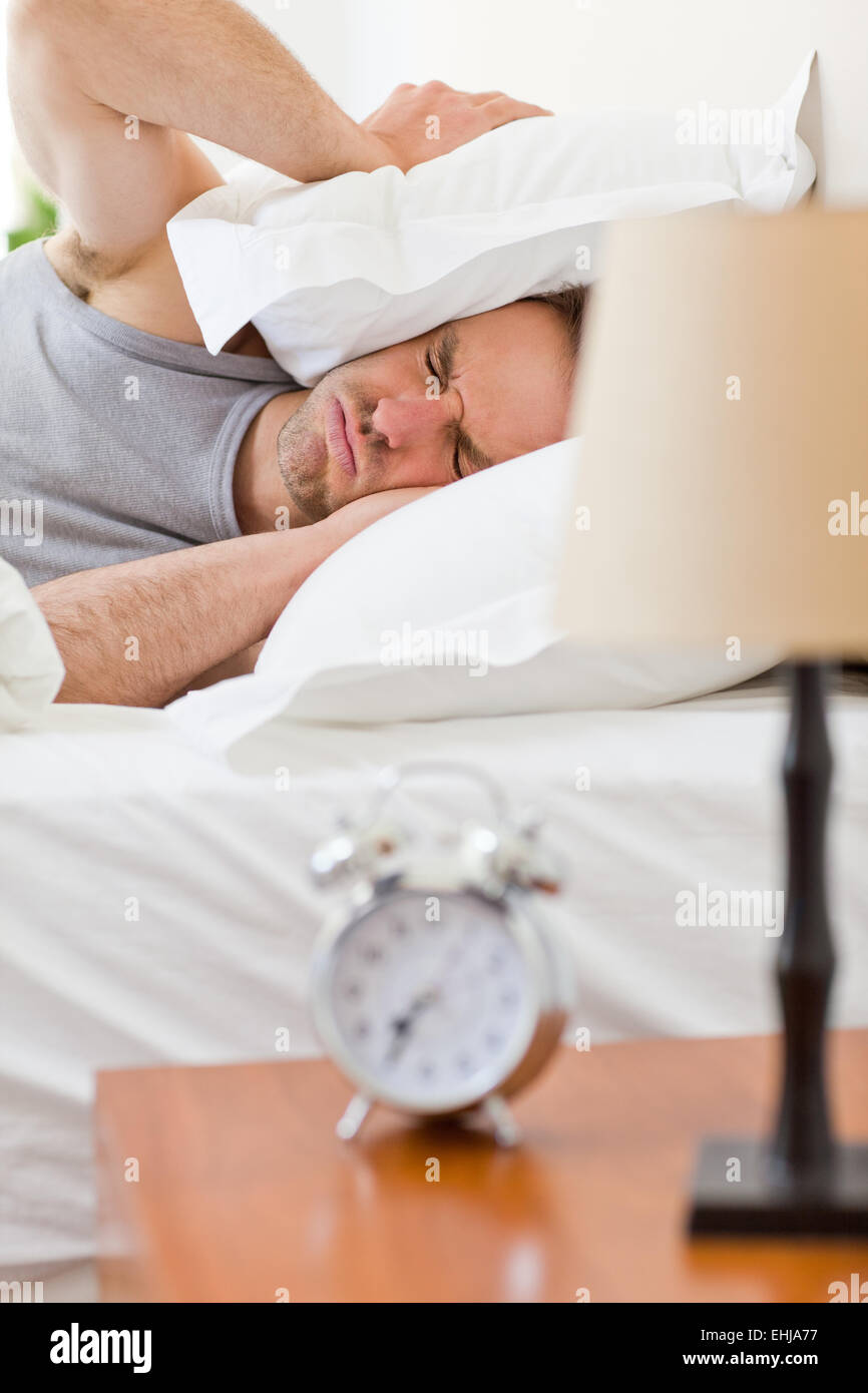 Man waking up in his bed Stock Photo - Alamy