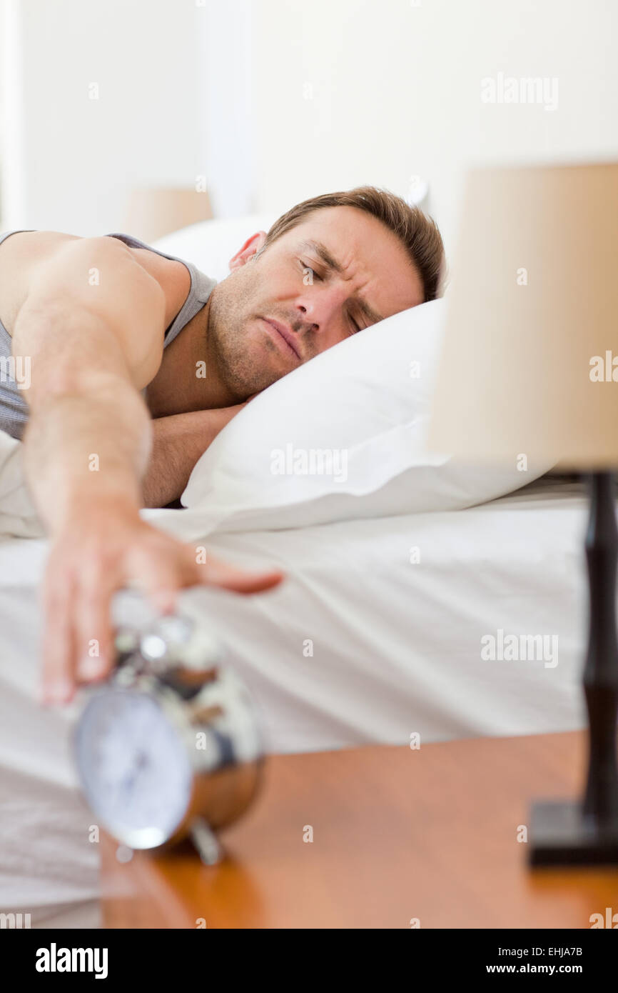 Man waking up in his bed Stock Photo - Alamy