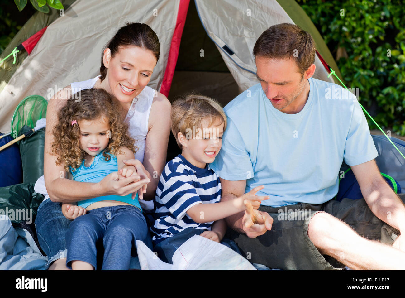 Adorable family camping in the garden Stock Photo - Alamy