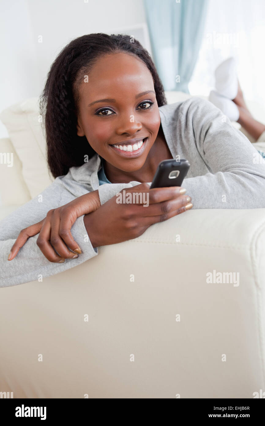 Close up of woman texting on couch Stock Photo - Alamy