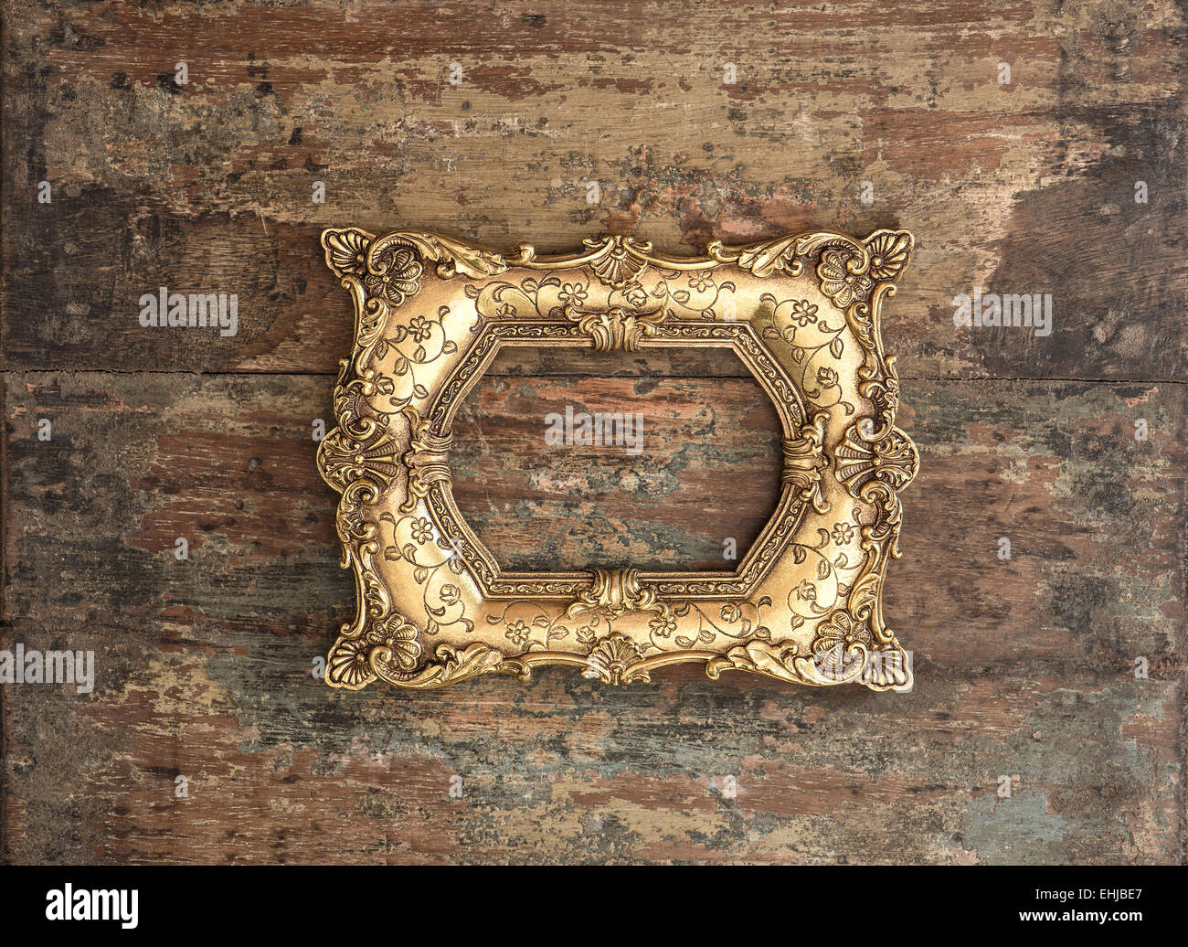 Baroque golden frame over rustic wooden background. Grunge wood texture ...
