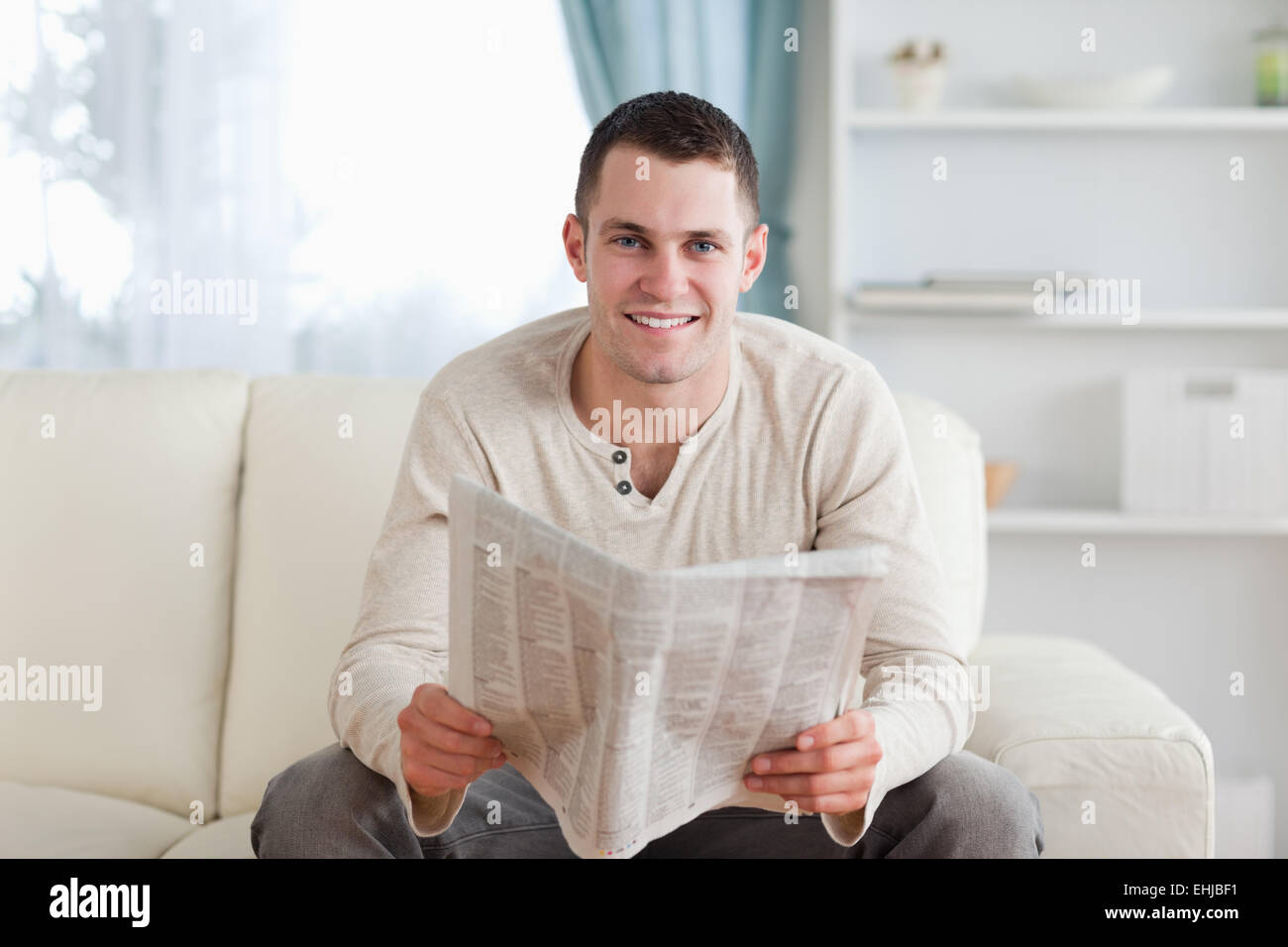 Man holding a newspaper Stock Photo - Alamy