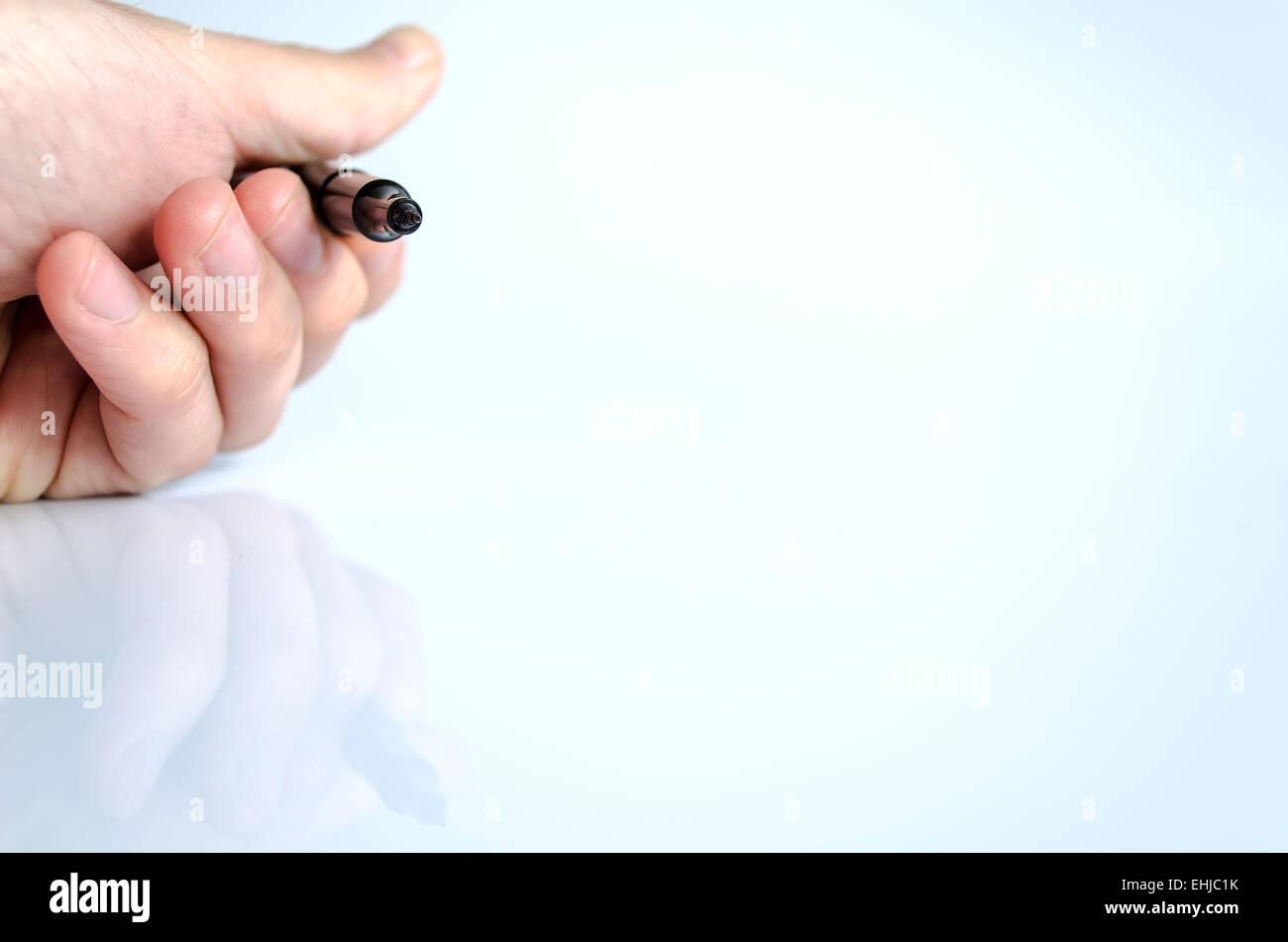 Pen in the hand isolated over white background Stock Photo - Alamy