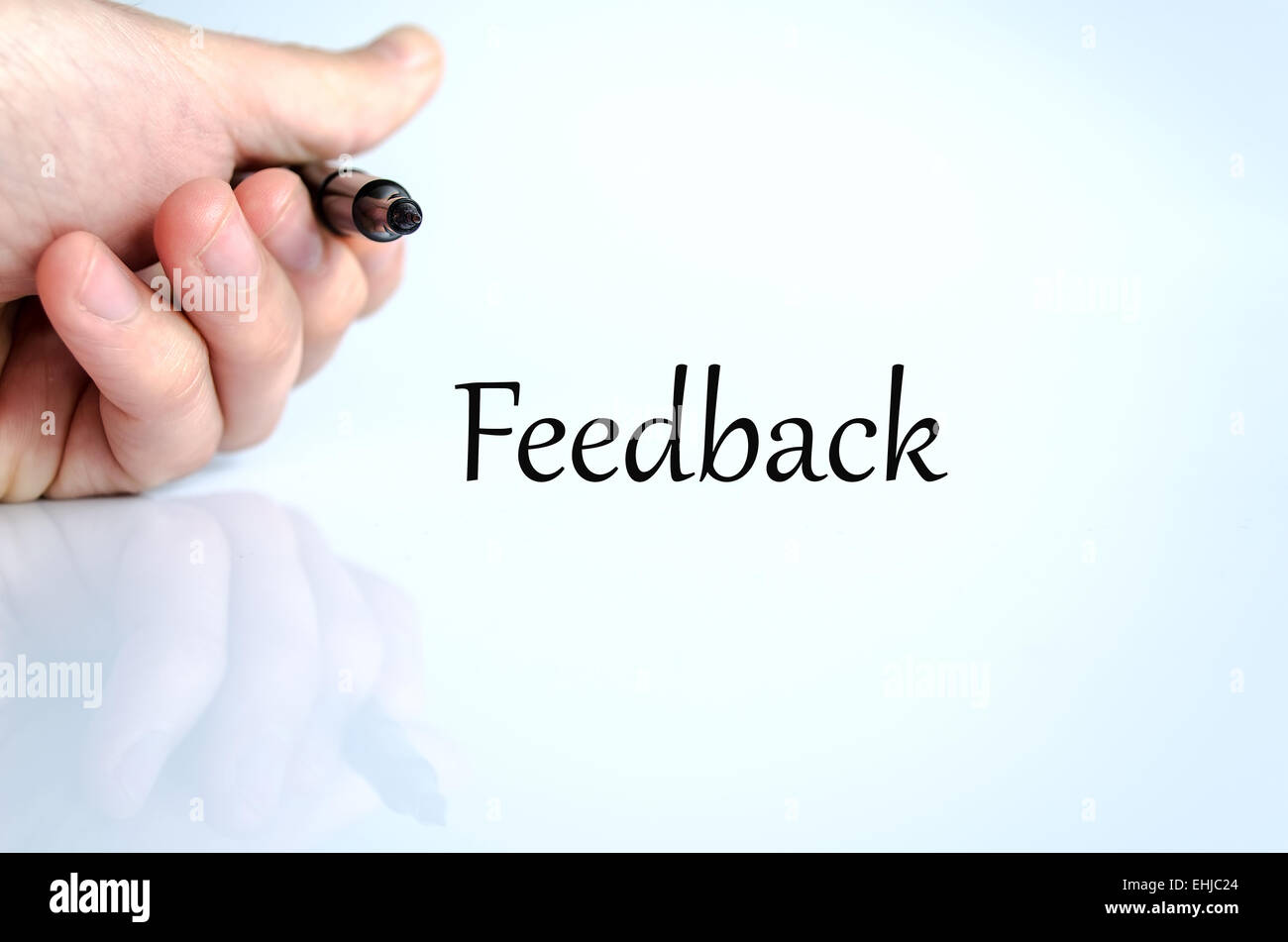 Pen in the hand isolated over white background Feedback Stock Photo - Alamy