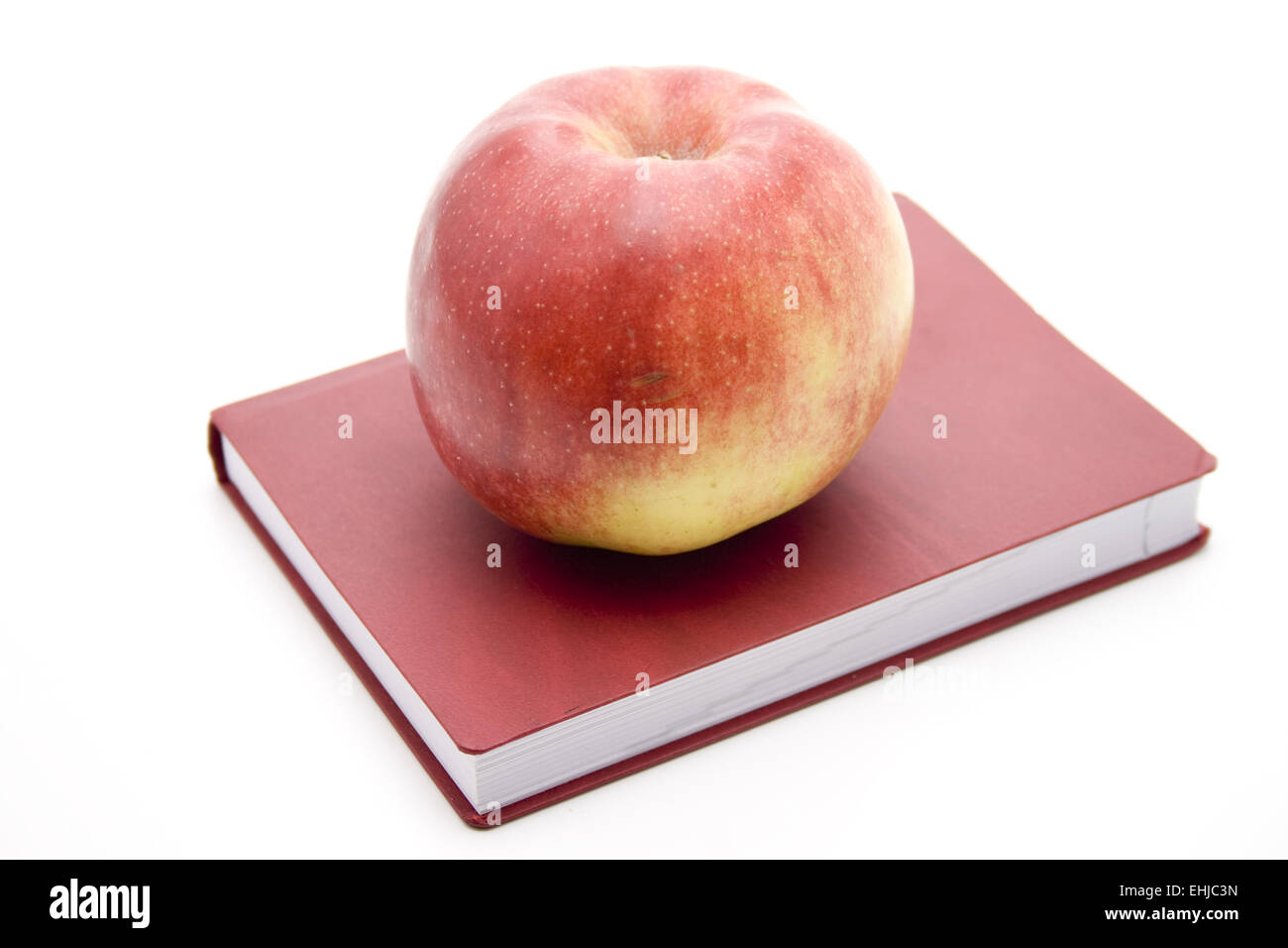 Red apple on book Stock Photo - Alamy