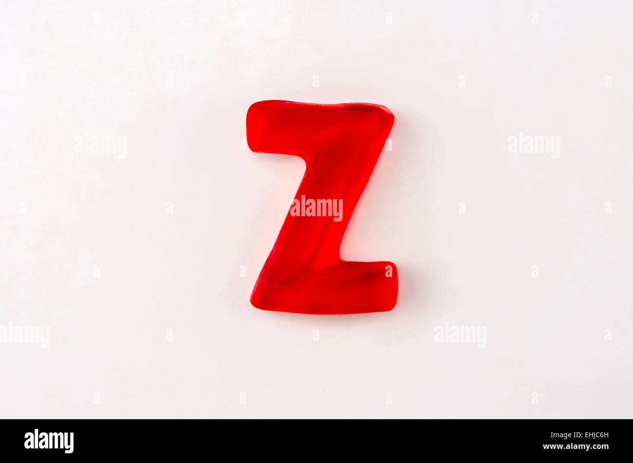 A red gummy letter in the shape of Z isolated on white Stock Photo - Alamy