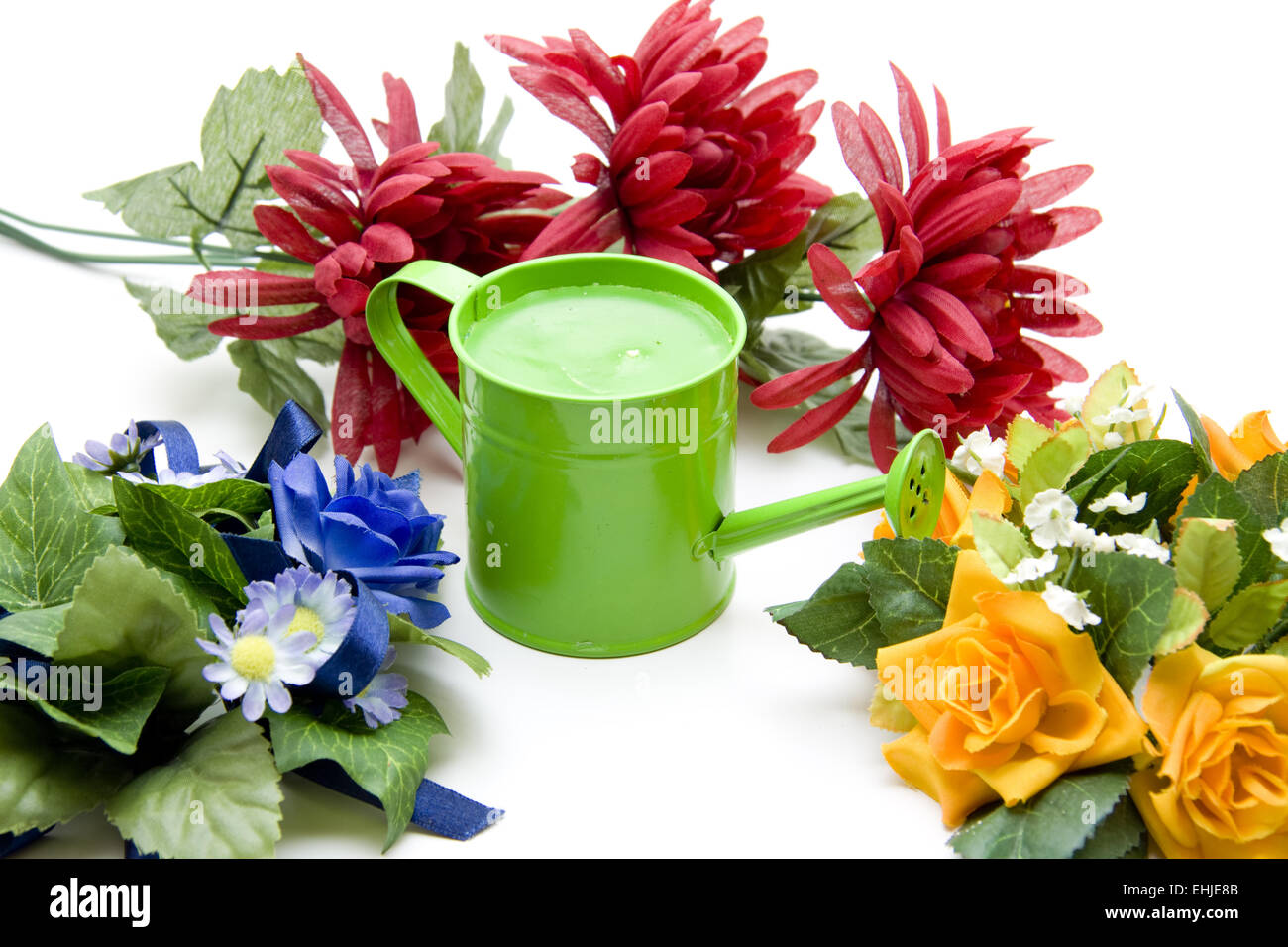 Watering can with flowers Stock Photo - Alamy